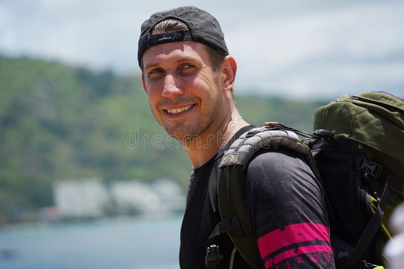 A Woman is Capturing a Photograph of a Man Who is Carrying a Backpack ...