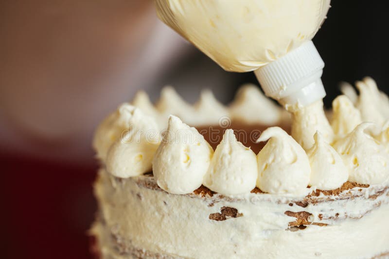 Woman Carefully Icing the Cake Stock Photo - Image of icing, beautiful ...