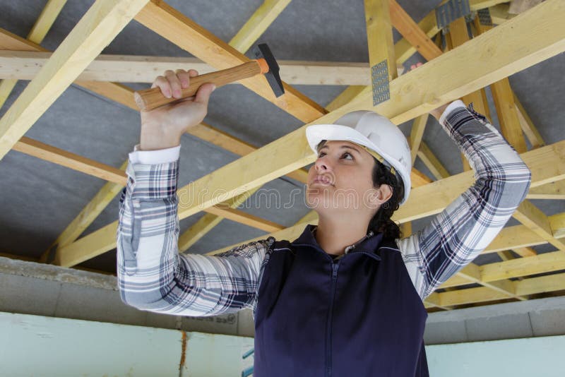 Woman Carpenter Using Hammer on Ceiling Stock Image - Image of ...