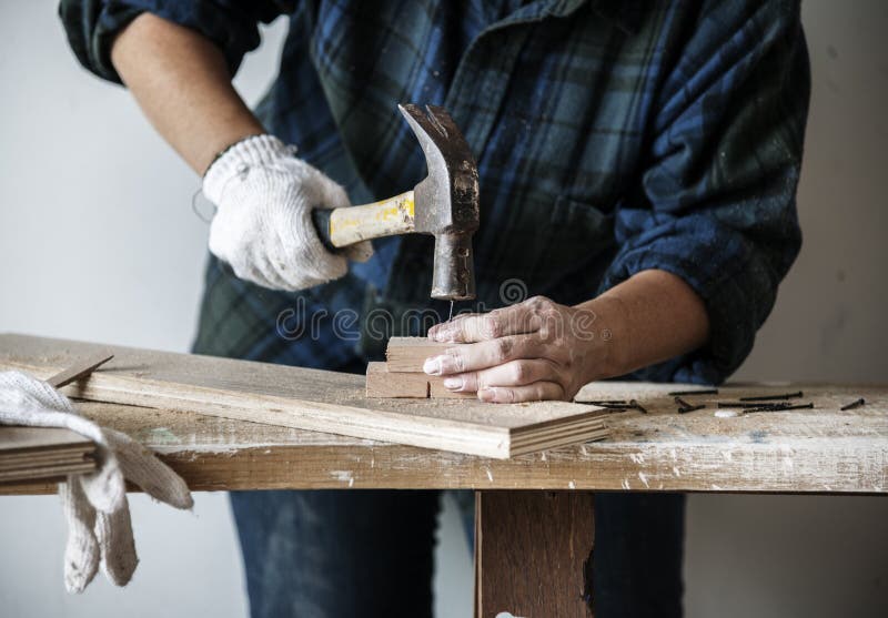 Woman Carpenter Using Hammer Pushing Nail on a Wood Stock Image - Image ...