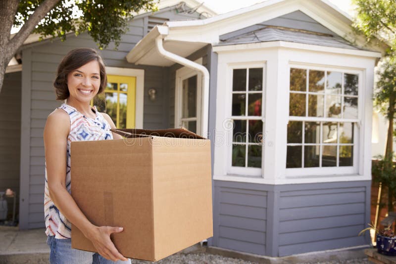 Woman Carrying Box into New Home on Moving Day Stock Photo - Image of ...