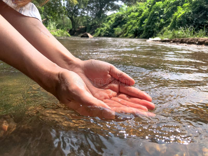 Woman Catches Running Water in Her Cupped Hands at Waterfall. Stock ...