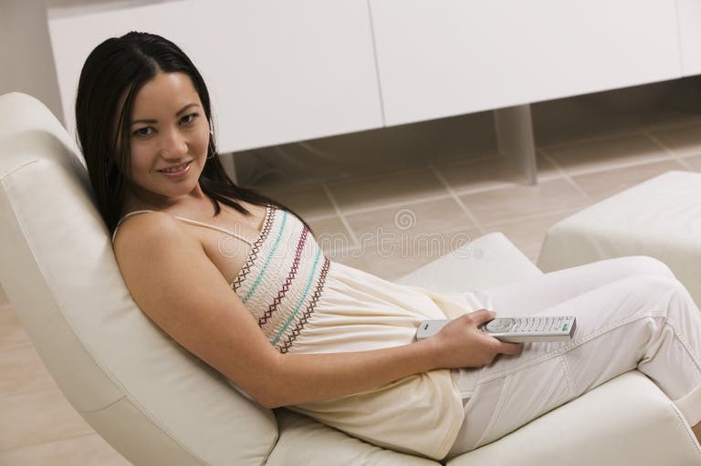 Woman in Chair with Remote Control Stock Image - Image of interior ...