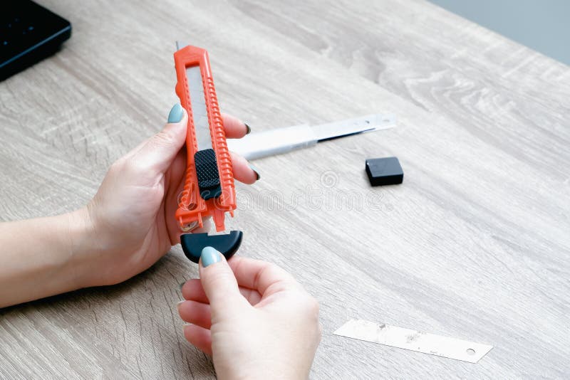 A Woman Changes a Blade in a Mounting Knife. Hands Hold the Knife and ...