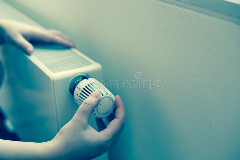 Woman Changing the Temperature on Radiator by Temperature Controller ...