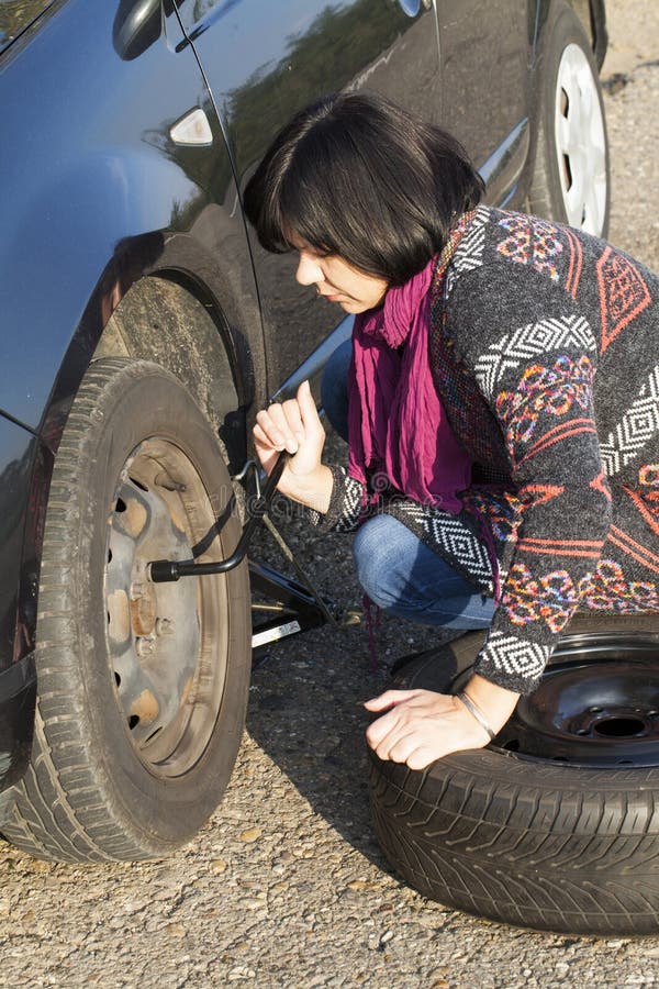 Woman Changing a Wheel on a Car on the Empty Road Stock Image - Image ...