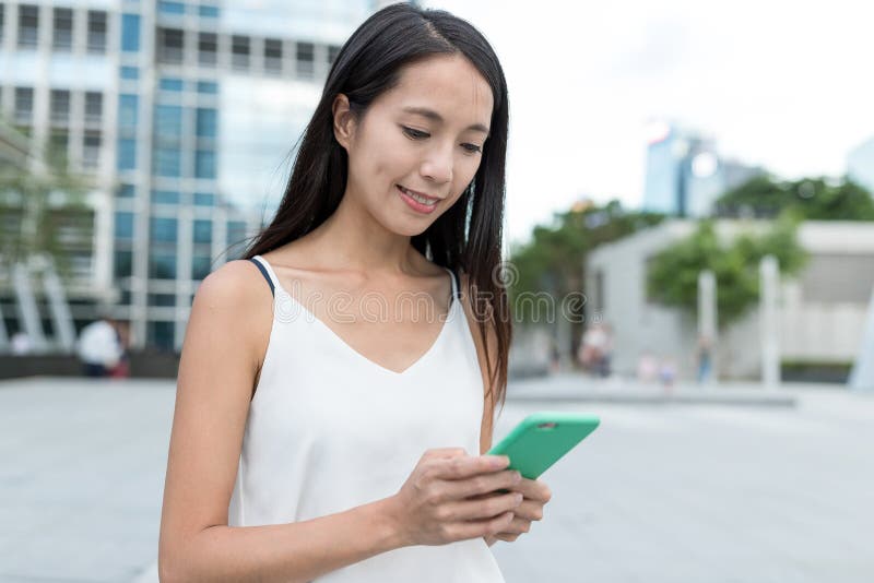 Woman Checking on Cellphone in City Stock Photo - Image of beam, asian ...