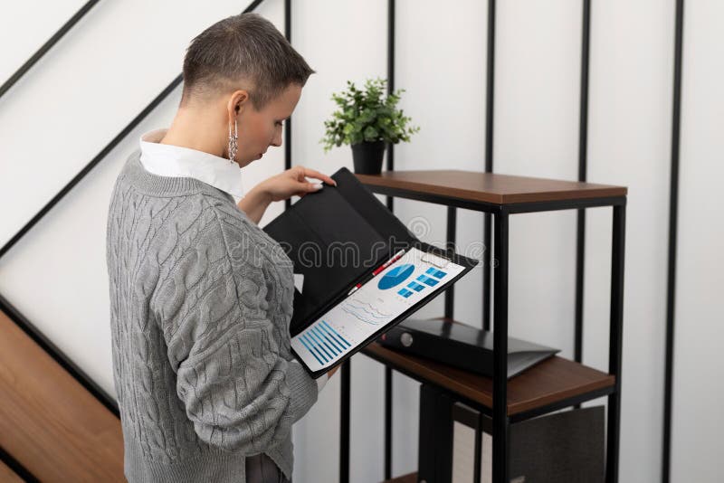 Woman Checking Documents in a Folder in a Stylish Office Stock Image ...