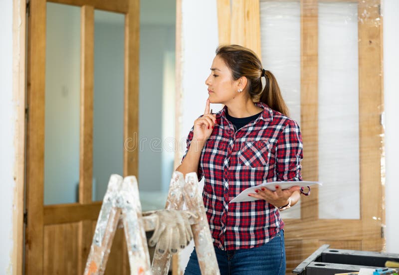 Woman Checking Documents Inside New Apartment Stock Photo - Image of ...