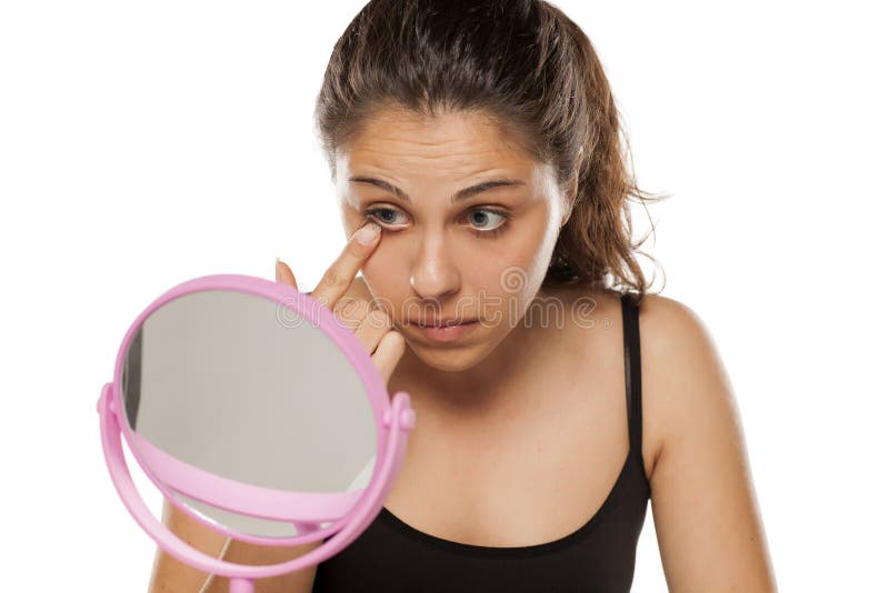 Woman checking her face stock image. Image of female - 94792313