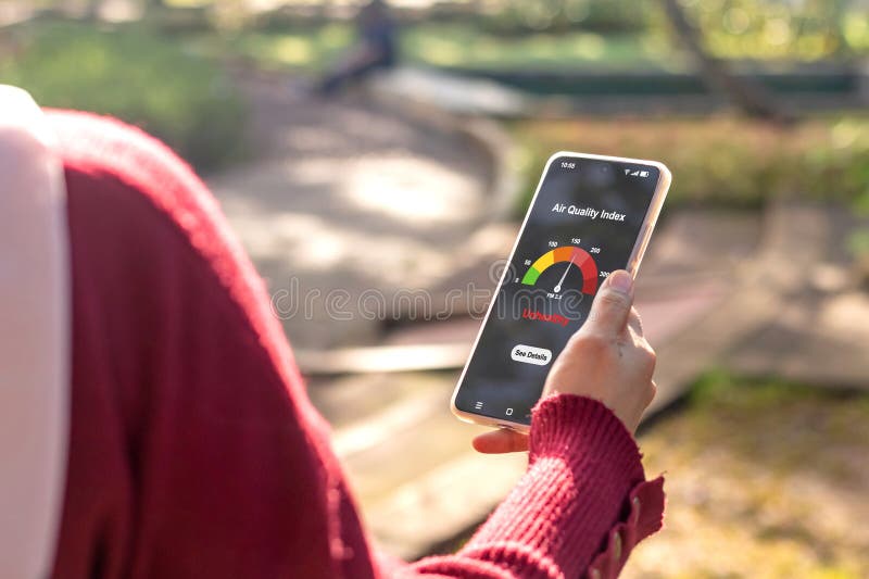 A Woman Checking the Outdoor Air Quality Index Using an App on Her ...