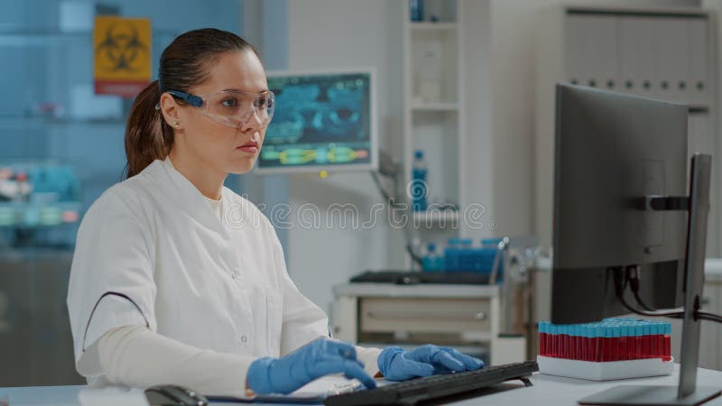 Woman Chemist Taking Notes for Science Research in Laboratory Stock ...