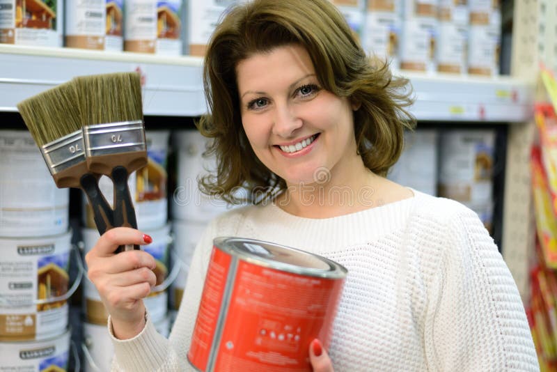 Woman Chooses Paint and Brushes in Store Stock Photo - Image of female ...
