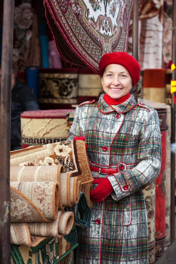 Woman chooses rug stock photo. Image of people, choice - 21896512