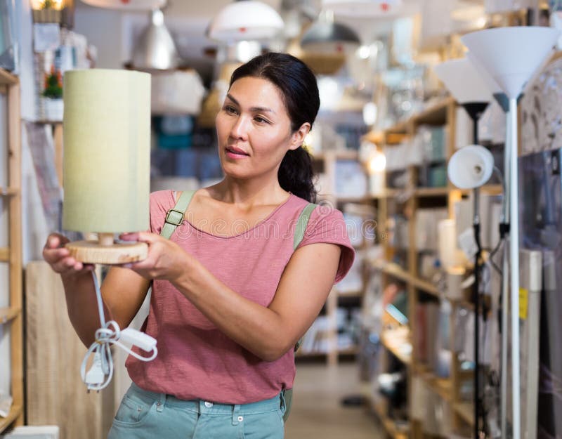 Woman Chooses Table Lamp in an Electrical Store Stock Photo - Image of ...