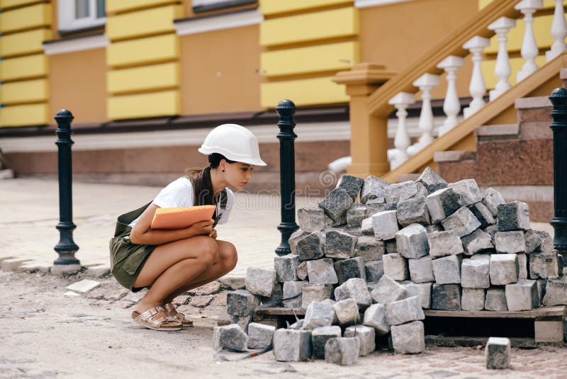 Woman Civil Engineer Counts Building Materials at a Construction Site ...