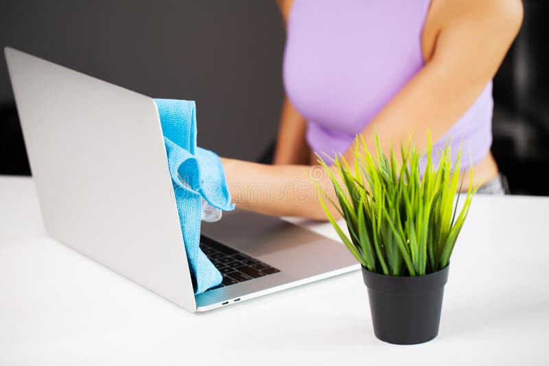 Woman Cleaner Tidies Up the Computer Desk in the Office. Stock Photo ...