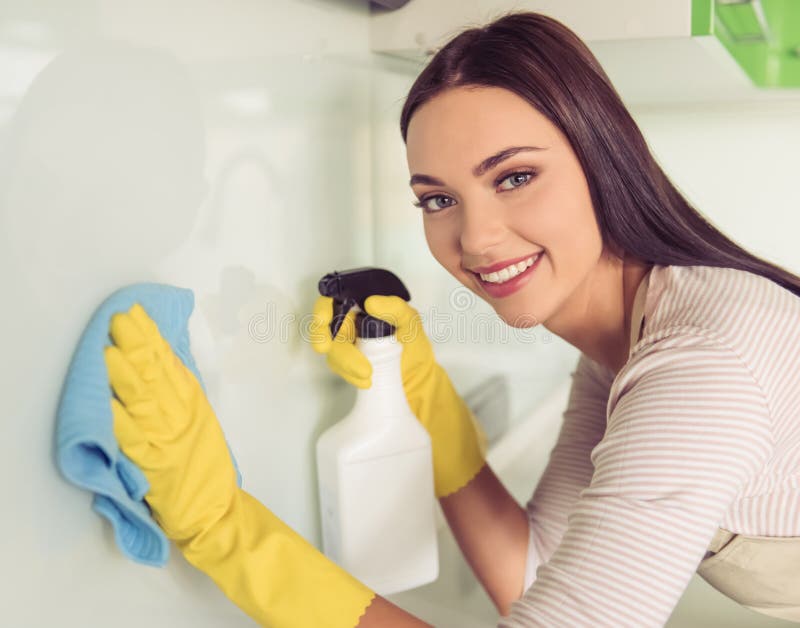 Woman cleaning her kitchen stock image. Image of bottle - 80100355