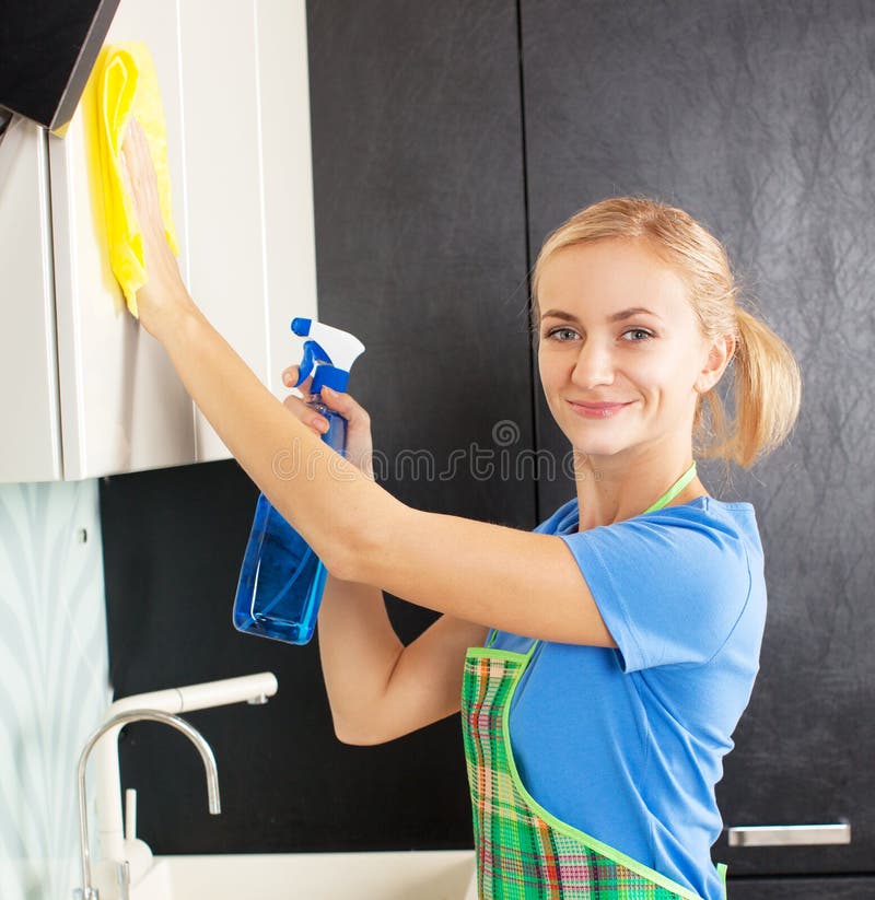 Female Cleaner Holding a Bottle of Detergent and Posing at Home Stock ...