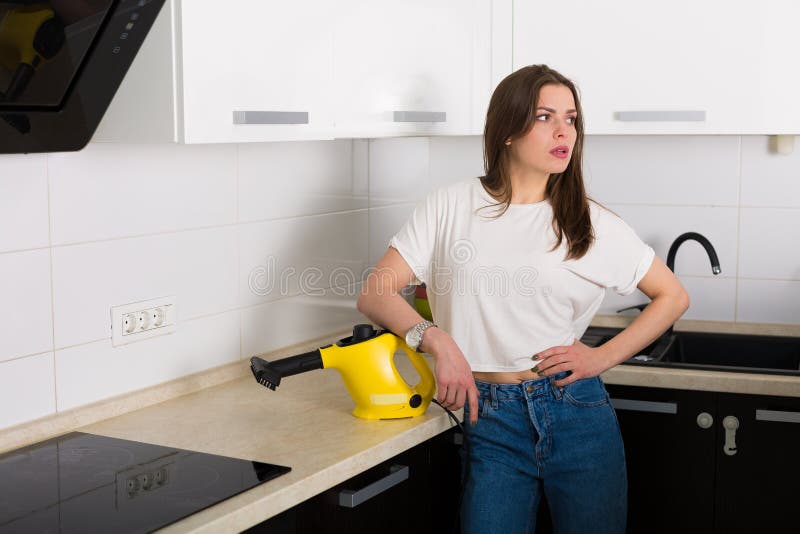 Woman Cleaning Kitchen with Steam Cleaner Stock Image - Image of jeans ...