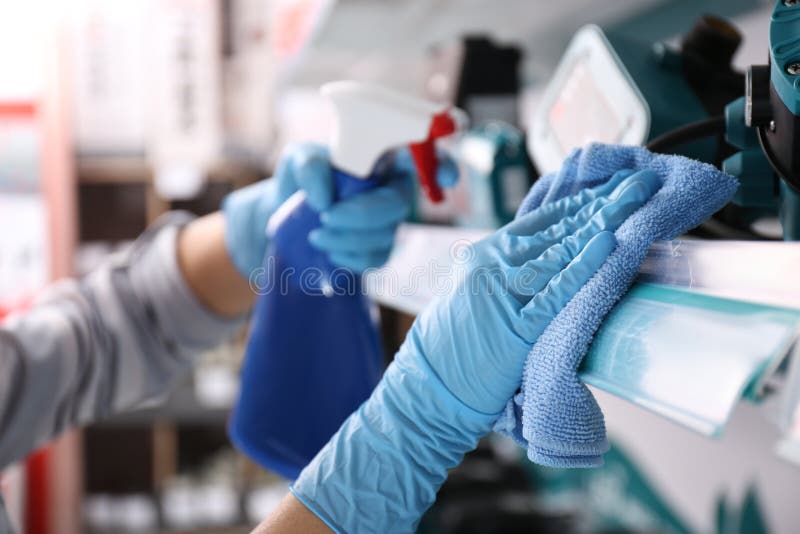 Woman Cleaning Shelf with Rag and Detergent in Store, Closeup Stock ...