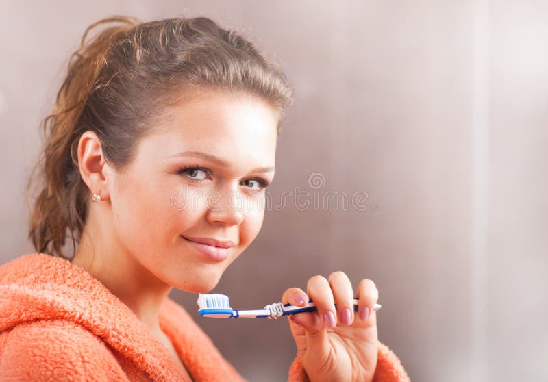 Woman cleaning teeth stock image. Image of orange, brush - 15346805