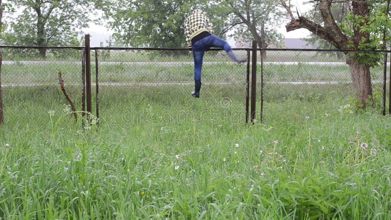 Woman climb fence rain stock video footage. Video of adult - 37872539