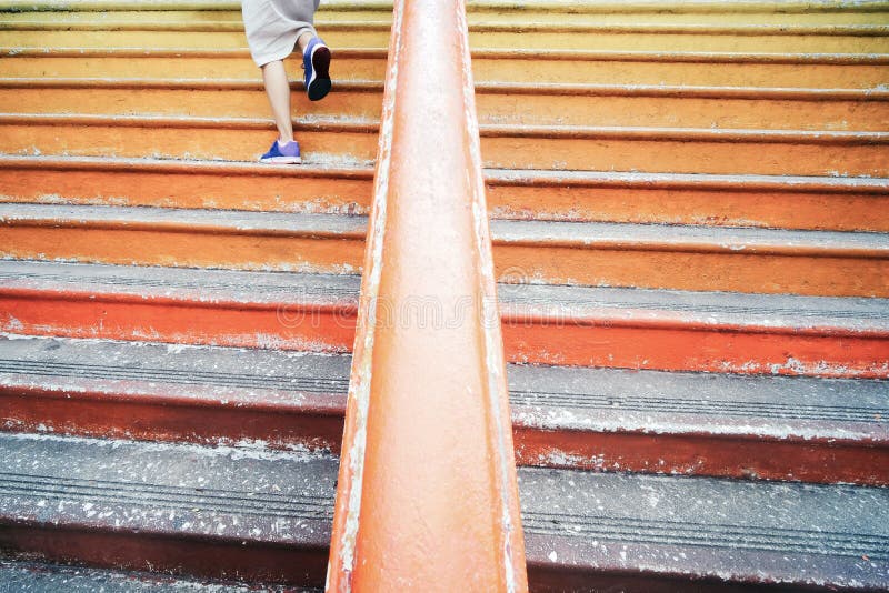 Woman Climbing Up the Old Orange Stairs. Stock Image - Image of ...