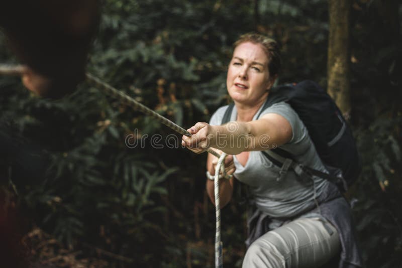 Woman climbing up a rope stock image. Image of explore - 116225987