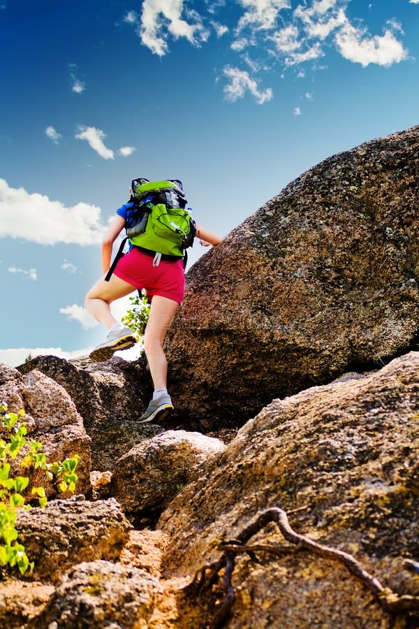 Woman climbs over a rock stock photo. Image of motivation - 27141962