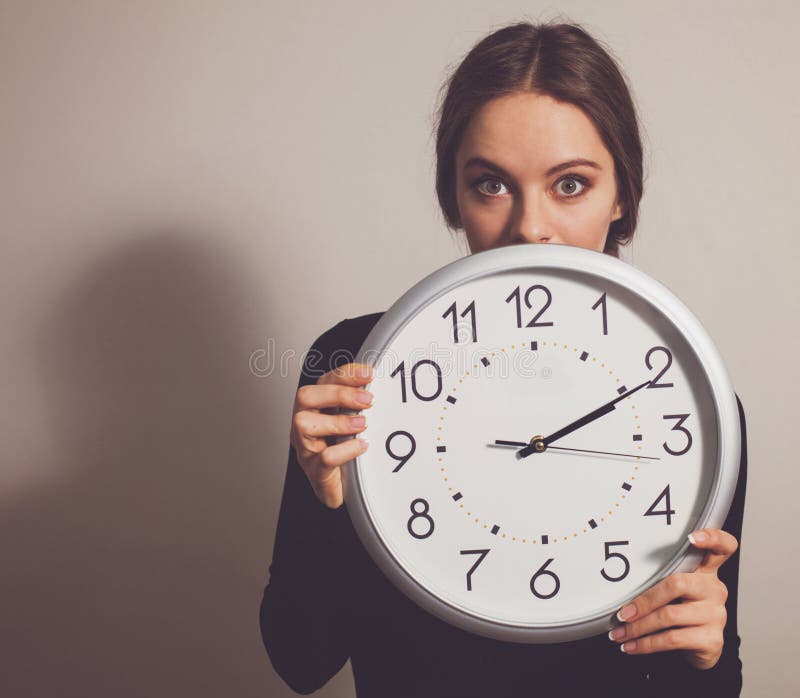Woman with clock stock photo. Image of showing, business - 83021126