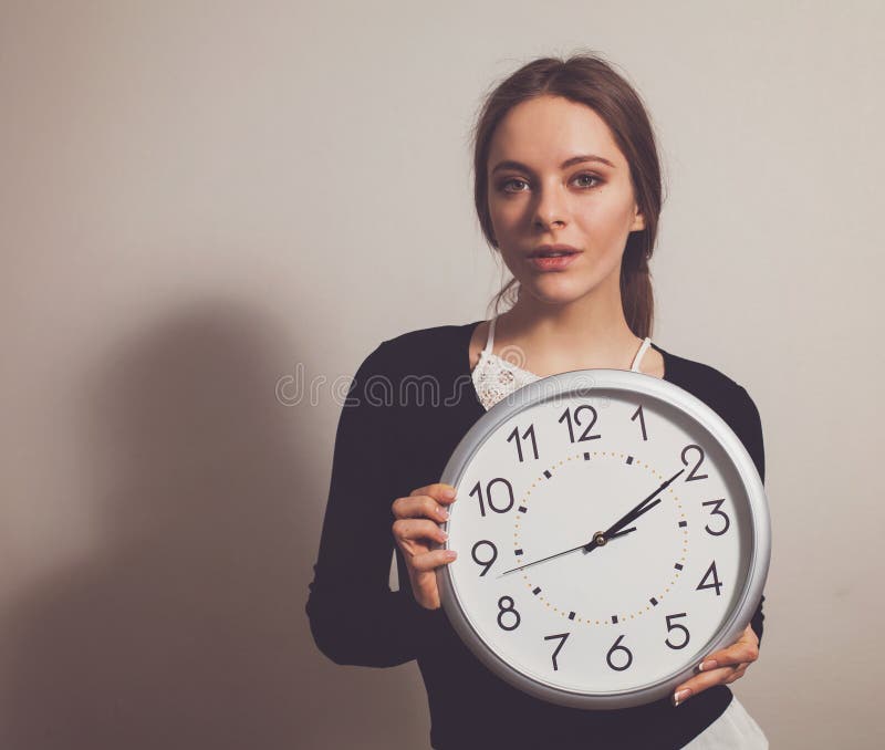 Woman with clock stock image. Image of woman, watch, holding - 83027649