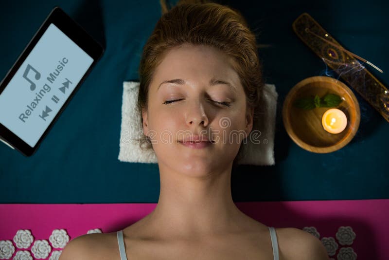 Woman With Closed Eyes Relaxing At Home Lying On Acupuncture Mat