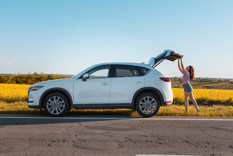 Woman Closing Car Trunk Parked at Roadside Stock Photo - Image of ...