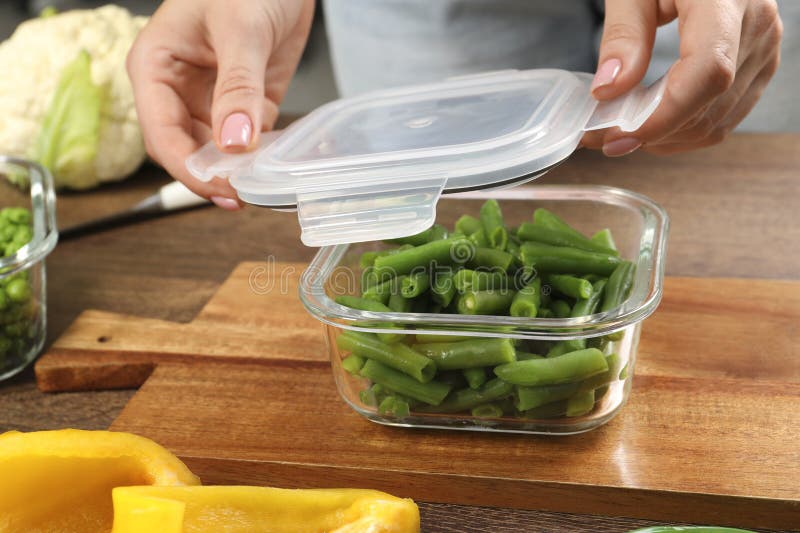 Woman Closing Container with Lid at Table, Closeup. Food Storage Stock ...