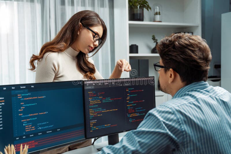 Woman Standing Opposite To Man Programmer Working on Desk To Discuss ...