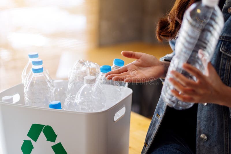 A Woman Collecting and Separating Recyclable Garbage Plastic Bottles ...