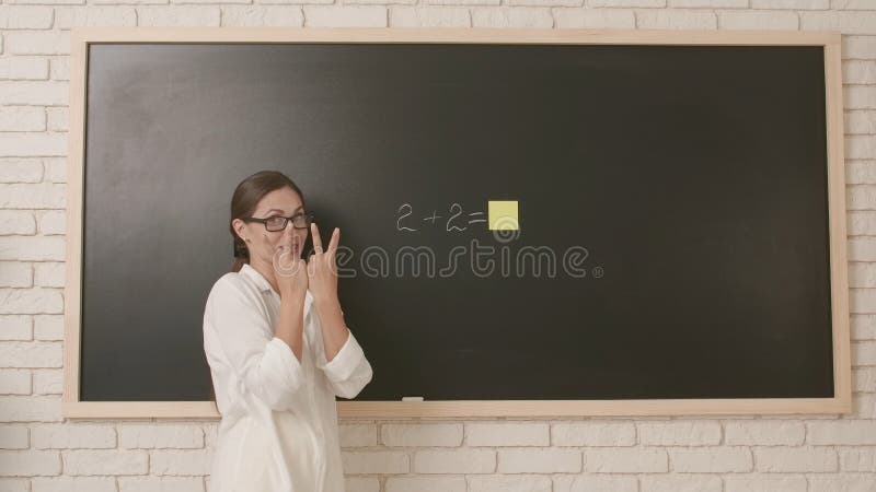 Woman College Teacher Standing in Classroom in Front of Chalkboard ...