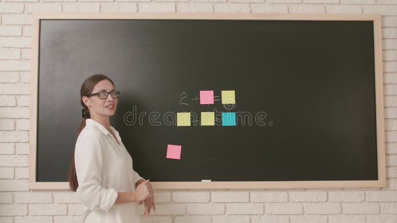 Woman College Teacher Standing in Classroom in Front of Chalkboard ...
