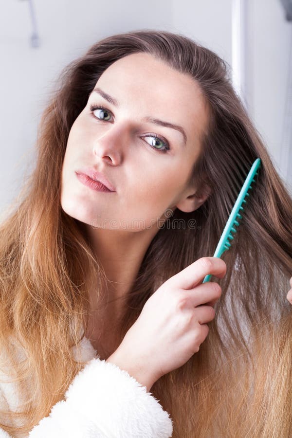 Woman combing hair stock photo. Image of young, long - 42331220