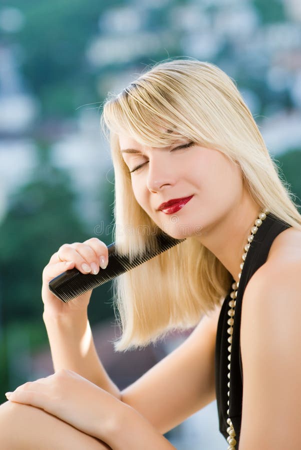 Woman combing her hair stock photo. Image of attractive - 5659254