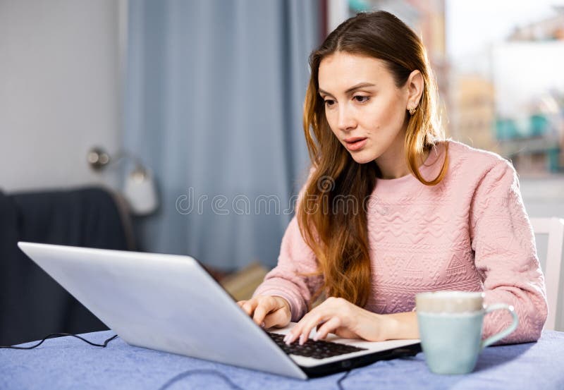 Woman Communicates Over Internet Using Laptop at Home Stock Photo ...