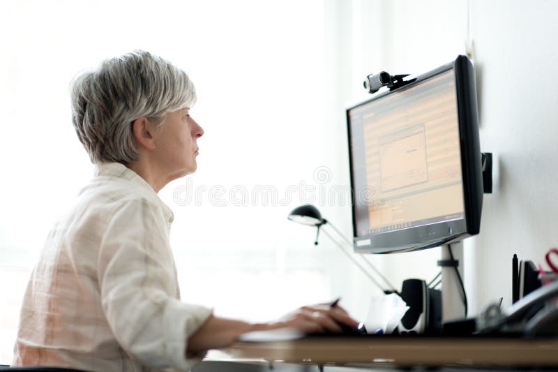 Woman at computer stock image. Image of raised, indoors - 20003787
