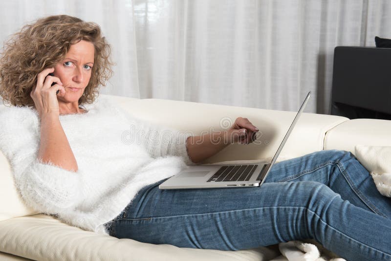 Woman with Computer on Couch Having a Phone Call Stock Image - Image of ...