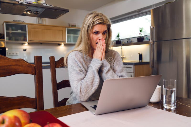 Woman with Computer at Home Looking Concerned Stock Image - Image of ...
