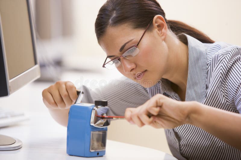 Woman in Computer Room Using Pencil Sharpener Stock Photo - Image of ...