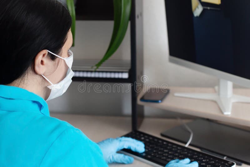 Woman at the Computer Wearing a Protective Mask and Gloves Stock Photo ...