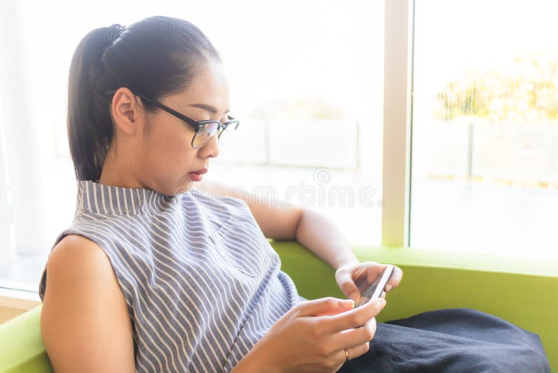 Woman Concentrate on Playing Mobile Game on the Sofa Stock Photo ...