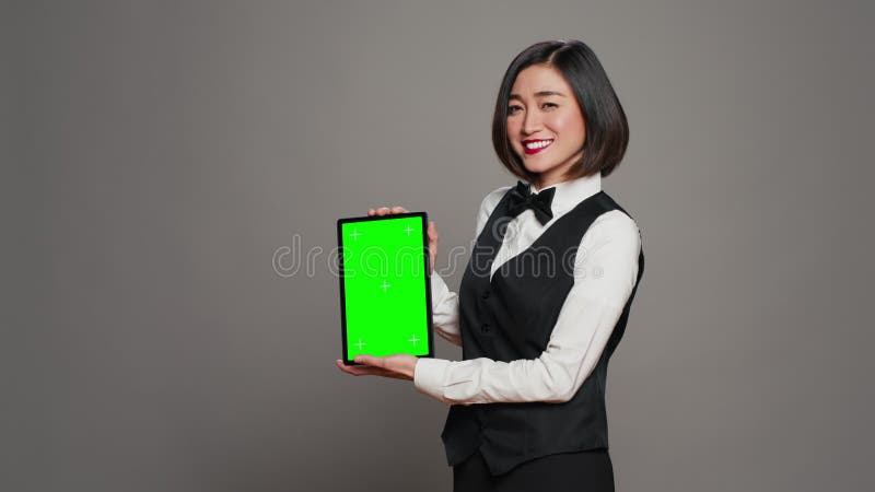 Woman Concierge Presenting Greenscreen Display on Tablet Stock Footage ...