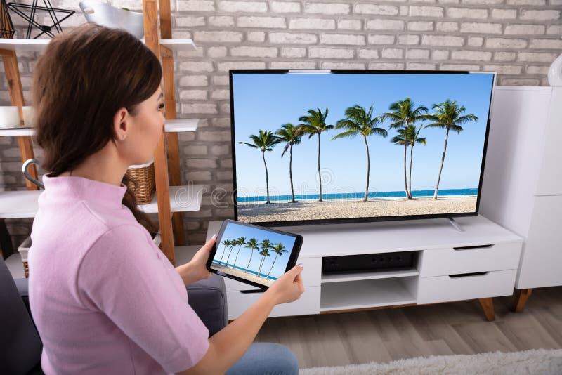 Woman Connecting Television Channel through Digital Tablet Stock Photo ...